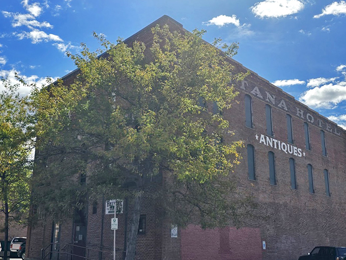 The Montana Antique Mall in its full architectural glory, where brick walls and blue skies frame a building that houses thousands of stories waiting to be taken home.