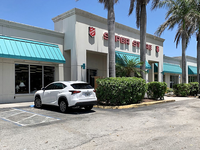 The classic white exterior with teal accents stands like a beacon of bargain hope under the Florida sun.