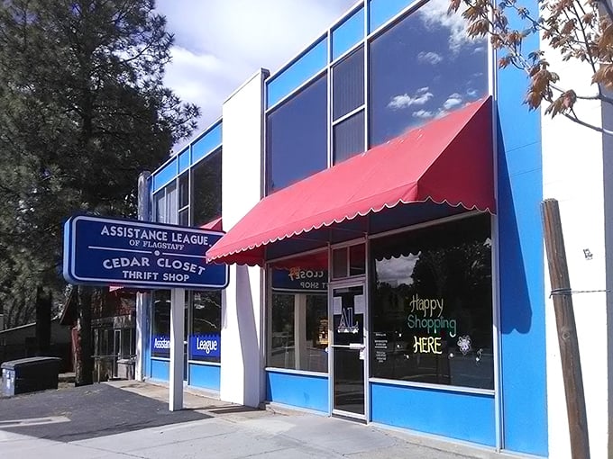 Happy Shopping HERE indeed! The cheerful storefront promises adventures in secondhand treasures just beyond those blue doors.