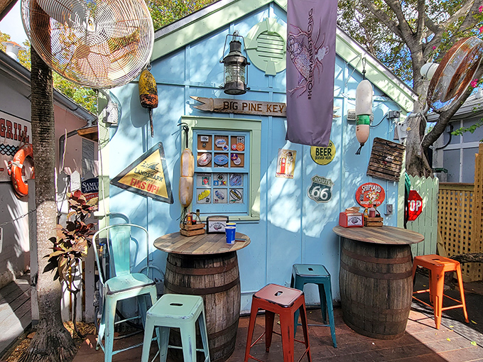 The outdoor seating area looks like it was decorated by a sea captain with excellent taste and a fondness for barrel tables.