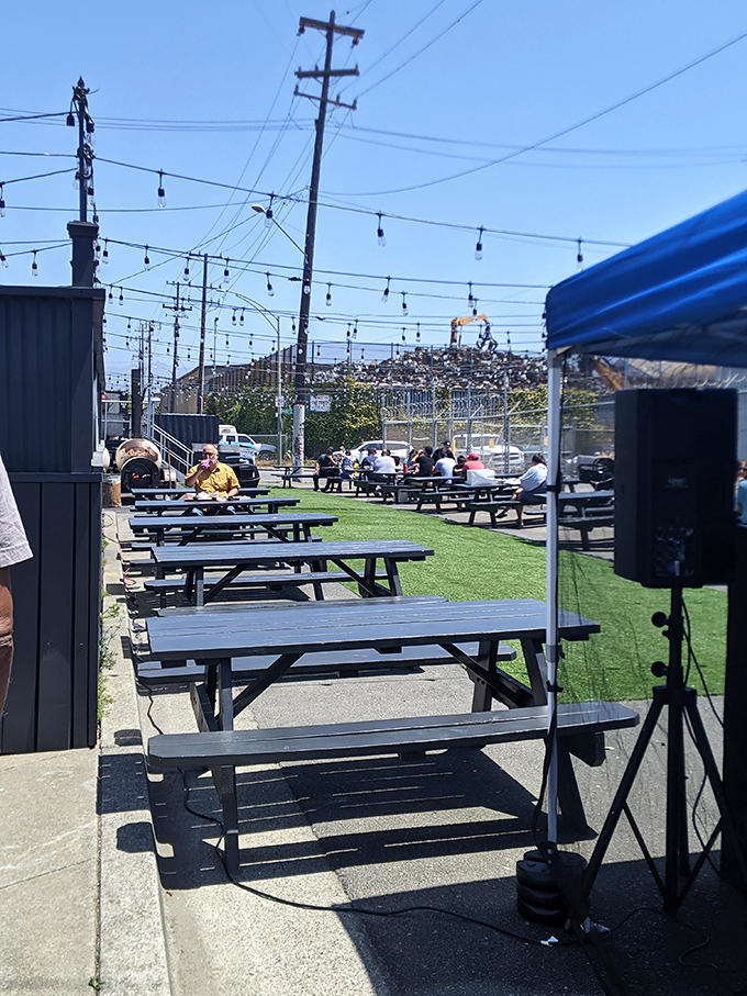 Outdoor seating where sunshine meets smoke signals. Some of life's best conversations happen at these picnic tables between bites.