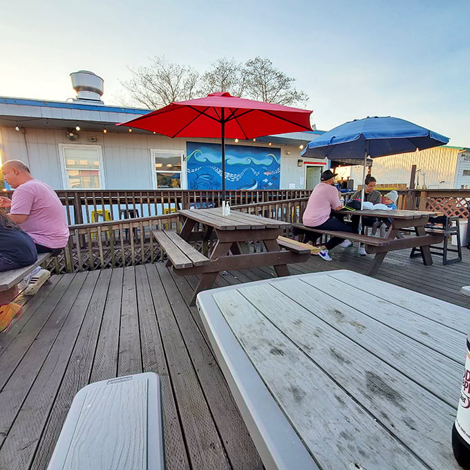 Weathered picnic tables under colorful umbrellas&mdash;the perfect stage for seafood feasts and conversations that linger like the taste of salt air. 
