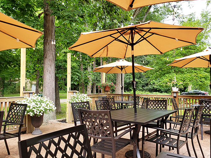 The outdoor patio where summer evenings stretch into night, with umbrella-shaded tables nestled among trees. Nature's dining room with better service.