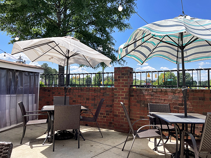The outdoor patio offers a peaceful retreat where umbrellas provide shade and conversations provide the perfect seasoning to any meal.