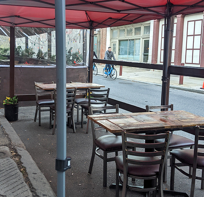 The outdoor seating area offers a front-row seat to Old City's street theater—perfect for people-watching while your pulled pork sandwich performs its own show.