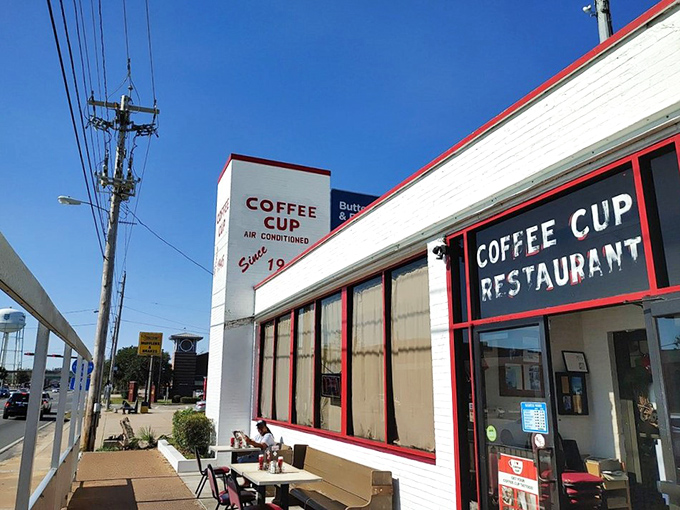 Florida sunshine bathes the outdoor seating area, where the Coffee Cup's iconic signage has guided hungry travelers for generations.