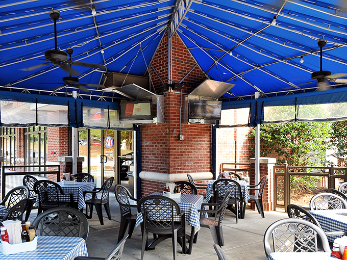 The blue-canopied patio offers al fresco dining with checkered tablecloths, because sometimes sandwiches taste better with a side of vitamin D.
