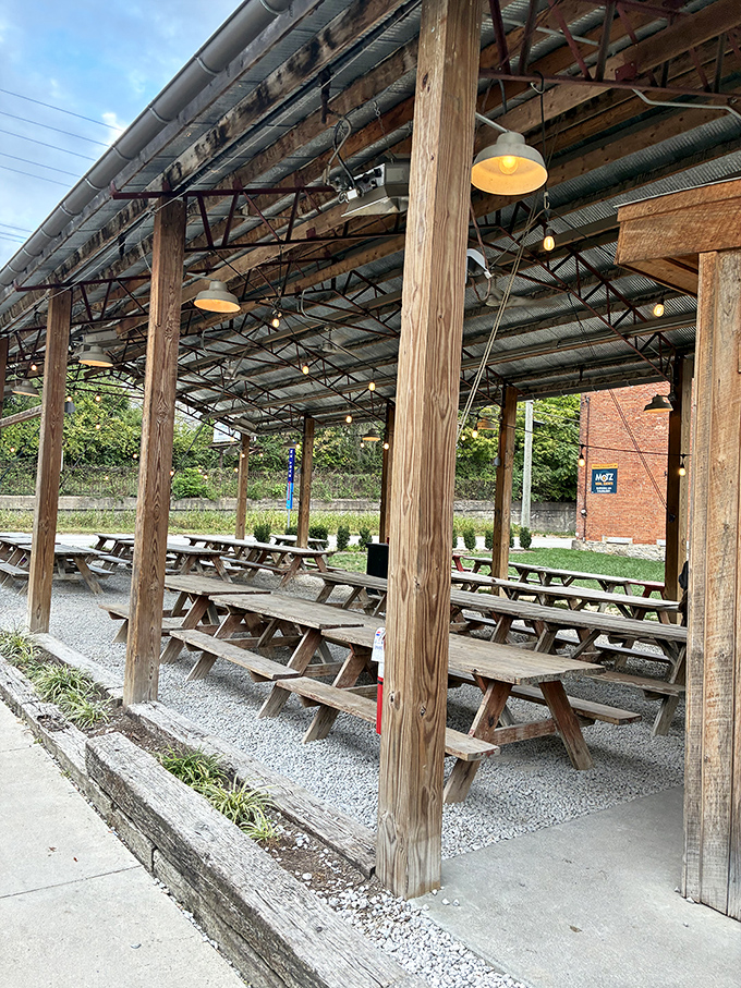 The outdoor seating area &ndash; where picnic tables under rustic wooden beams invite you to commune with both nature and barbecue.