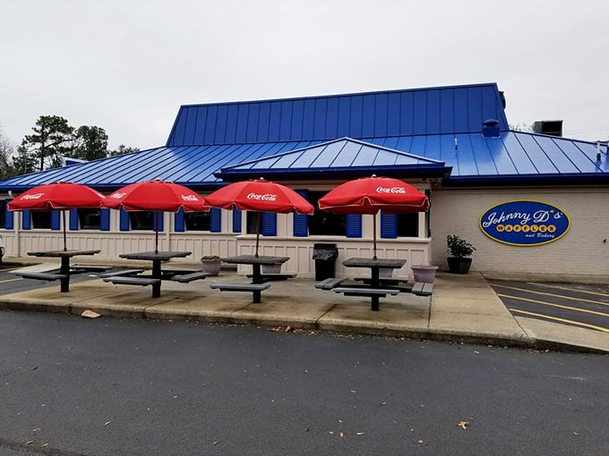 Red umbrellas shade outdoor tables where the ocean breeze enhances your coffee, proving some breakfasts are simply better alfresco.
