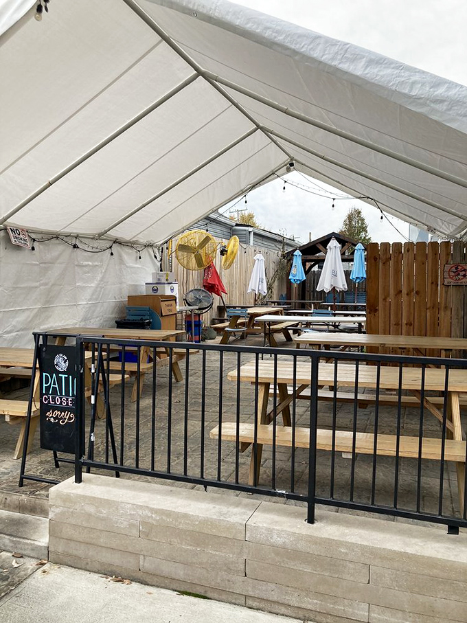 The outdoor patio awaits under a simple white tent&mdash;proof that good food tastes even better with fresh air and the casual charm of picnic table dining.