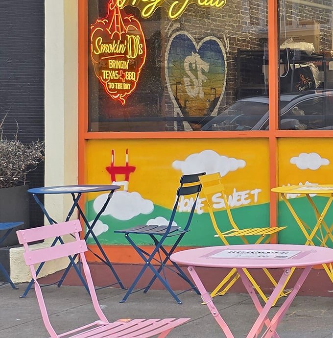Cheerful outdoor seating that looks like a Wes Anderson film set. Pink and blue tables where memories are made between bites of brisket.