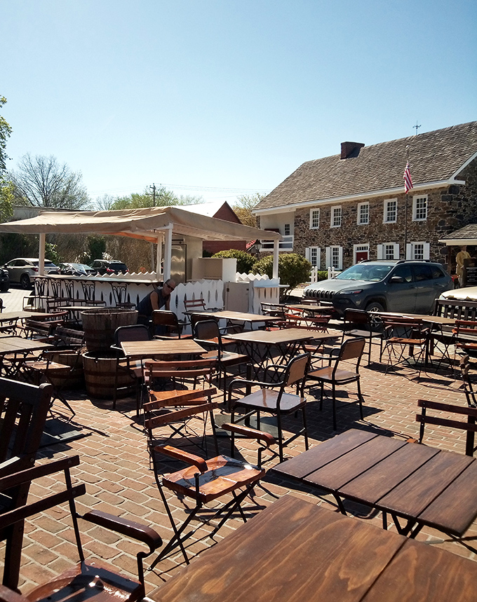 Outdoor dining among history—these tables have witnessed countless conversations while the stone building stands guard over precious memories.