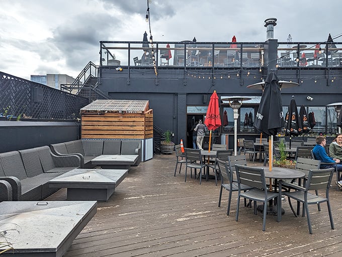 The rooftop deck where summer evenings stretch endlessly, and conversations flow as freely as the award-winning brews.