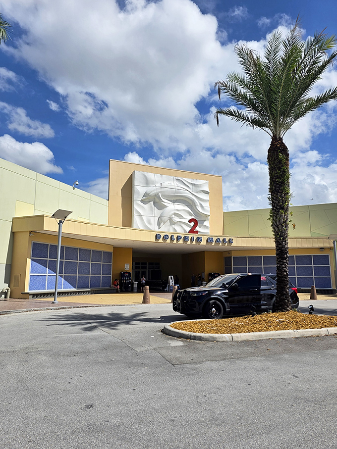 Entrance number 2 stands proudly under Florida's perfect cloud-scattered sky. That palm tree isn't just decoration—it's nature's way of saying "Welcome to Miami."