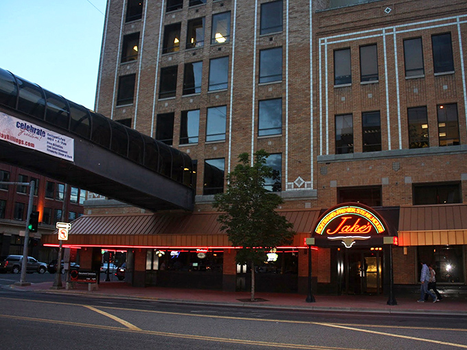 As evening falls, Jake's Downtown transforms from restaurant to landmark, its neon glow a familiar comfort in Montana's biggest city.