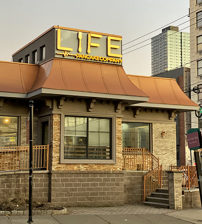 The illuminated sign glows like a lighthouse guiding hungry souls to breakfast salvation. Life Pancake Company isn't just a restaurant&mdash;it's a landmark for the famished.
