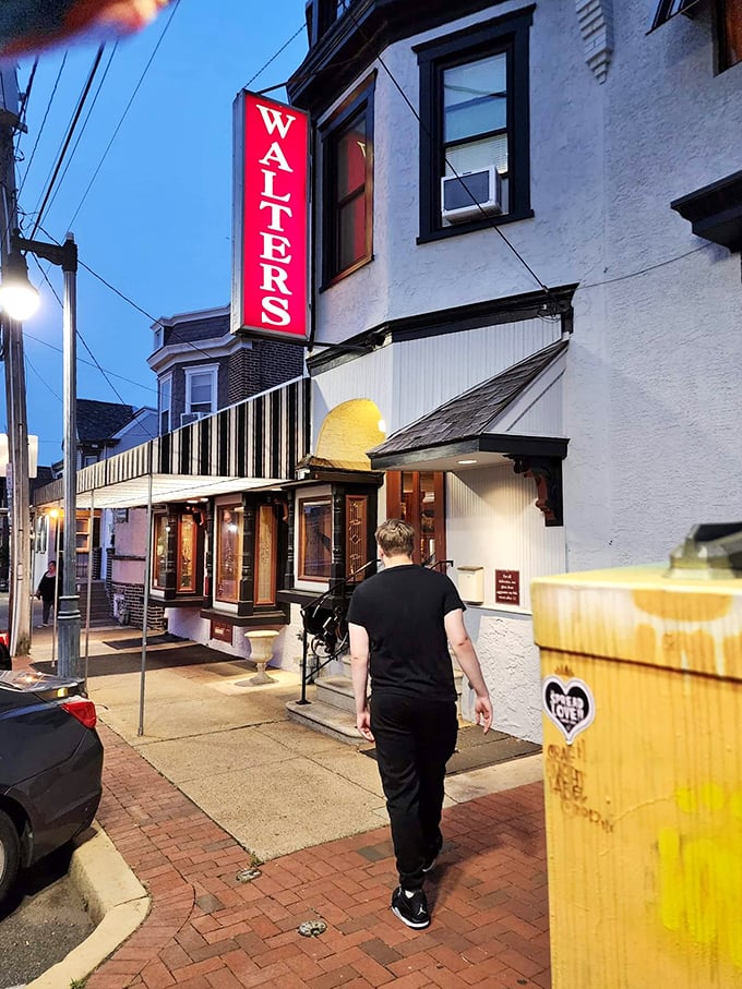 As dusk falls, the glowing Walter's sign serves as a beacon for those seeking refuge from mediocre meals and fast-food disappointments.