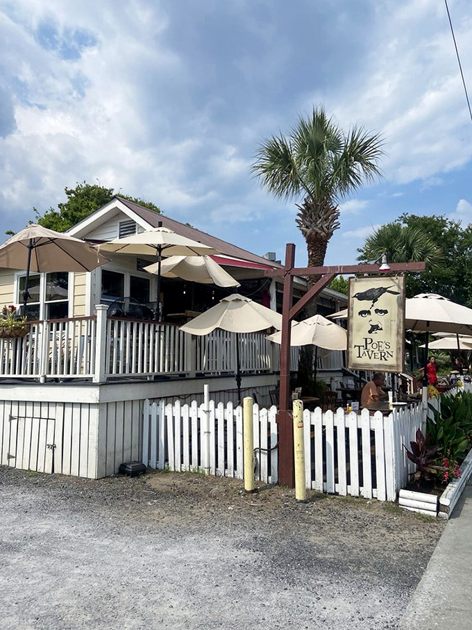 Even on cloudy days, Poe's Tavern shines as a coastal retreat. The white picket fence isn't just charming—it's practically a welcome committee.