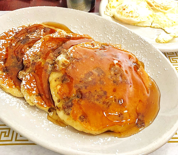 Pancakes swimming in maple syrup with a dusting of powdered sugar&mdash;like little floatation devices in a sea of sweet, sticky happiness.