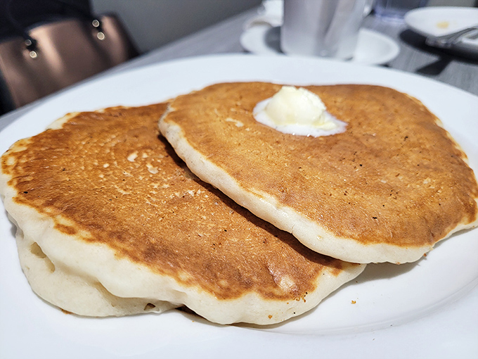 Pancakes that achieve the impossible trifecta: golden-crisp edges, cloud-soft centers, and the structural integrity to support that melting butter crown.