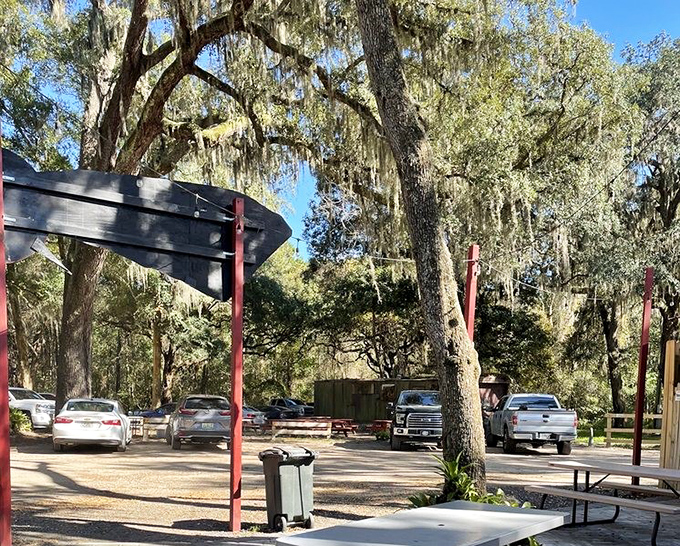 A parking lot filled with vehicles ranging from work trucks to luxury sedans. Good BBQ is the great equalizer&mdash;bringing together Floridians of all stripes.