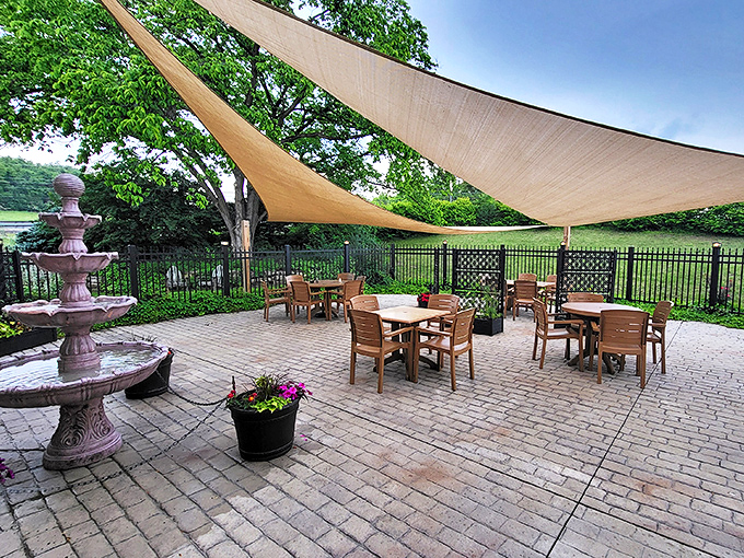 The outdoor patio where history meets fresh air. A fountain provides gentle background music while you dine beneath shade sails on warm Pennsylvania days.