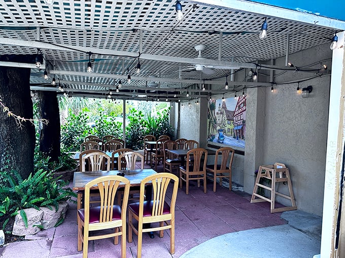 The outdoor patio offers al fresco dining with a German twist. String lights and greenery create an unexpected oasis for enjoying schnitzel under the Florida sky.
