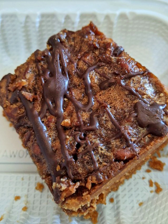 Not just dessert, but the grand finale your meal deserves—a pecan bar with chocolate drizzle that makes sharing seem like a terrible idea.