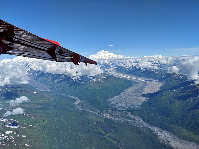 The ultimate Alaska selfie stick: a plane wing framing Denali and glacial rivers below. Social media envy guaranteed, reception not included.