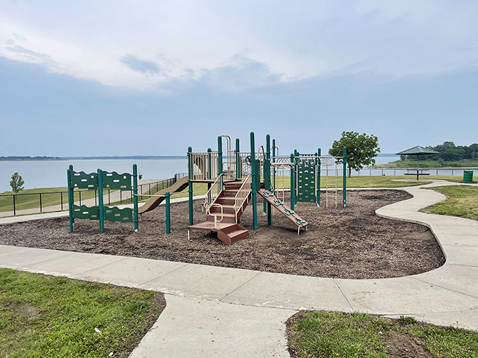 Playground with a view: where kids burn energy while parents soak in scenery. The lake provides the perfect backdrop for childhood adventures.