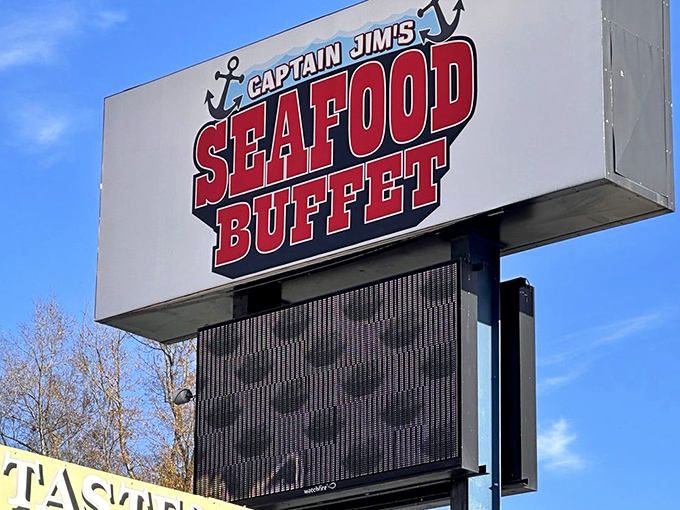 The sign stands like a lighthouse beacon, guiding hungry travelers to a seafood oasis in the Smoky Mountain foothills.