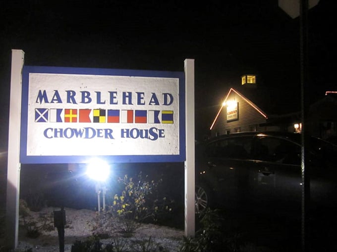 As darkness falls, the illuminated Marblehead sign becomes a lighthouse for hungry travelers. Those nautical flags spell "delicious" in any maritime language.