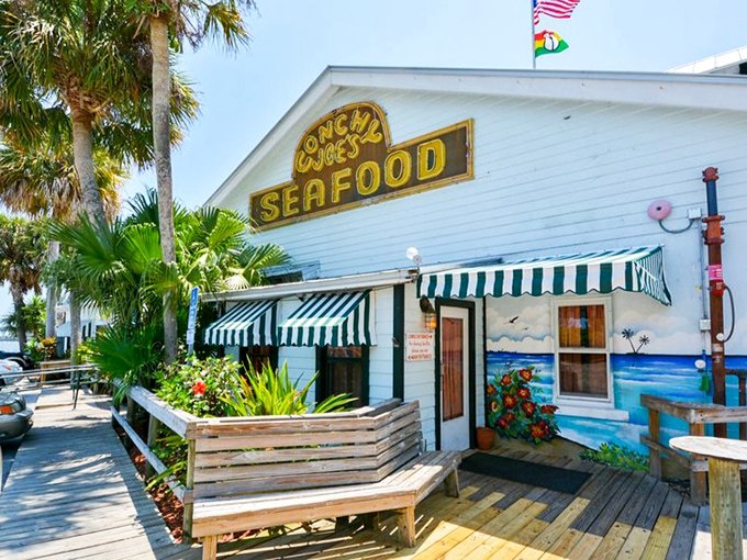 Like a beacon to seafood pilgrims, Conchy Joe's cheerful yellow sign promises tropical escape. Those green-striped awnings have sheltered countless happy diners from everything except food envy.