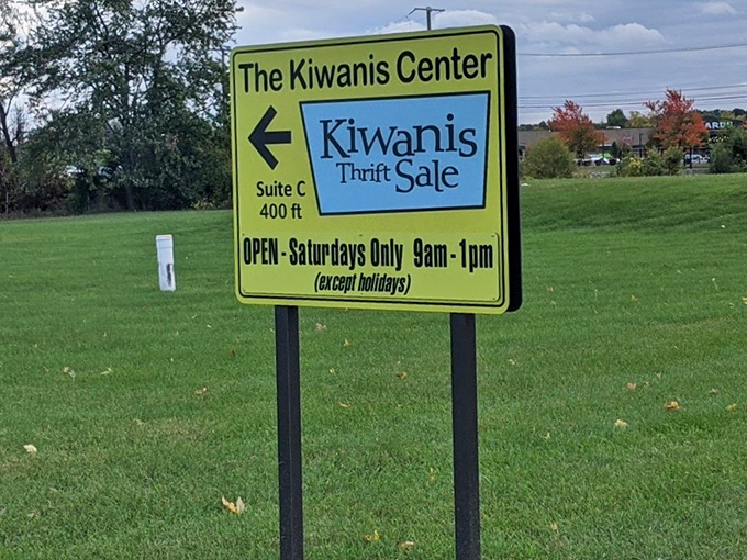 The roadside sign promises Saturday adventures for savvy shoppers who know where real bargains hide.
