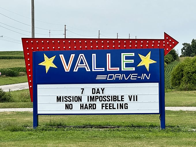 The classic arrow-shaped sign announces today's double feature, a roadside beacon calling movie lovers to gather as darkness falls.