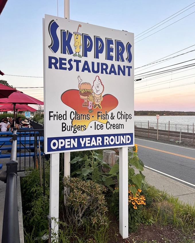 The iconic sign against the twilight sky &ndash; a beacon for hungry travelers and locals alike, promising seafood salvation just steps away.
