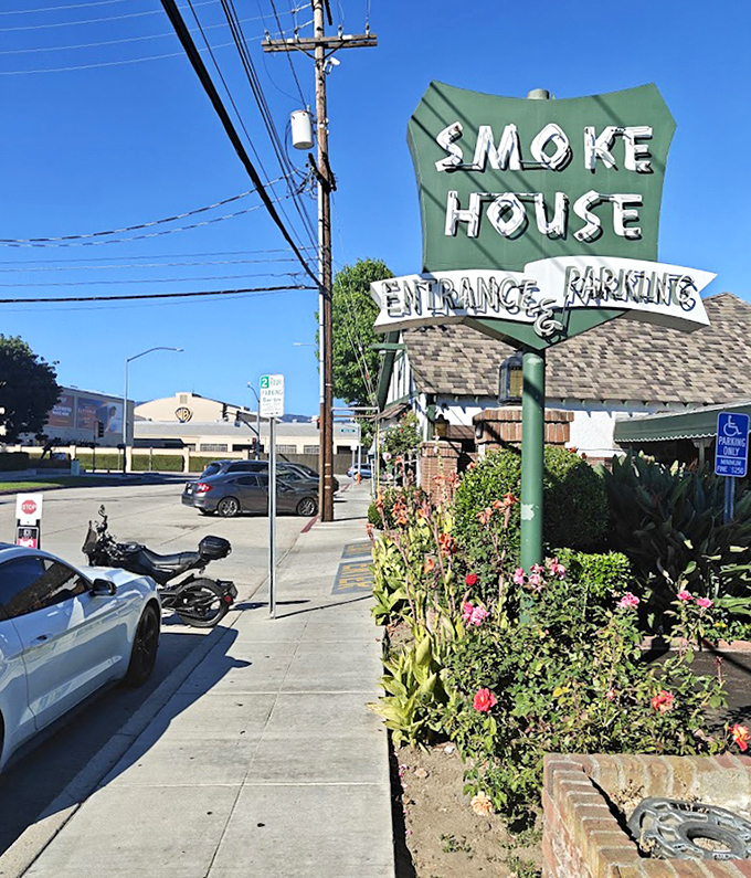 The iconic green sign stands as a landmark for both locals and lost tourists, pointing the way to ribs that will haunt your dreams.