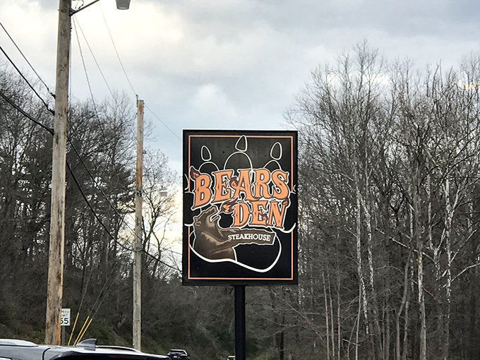 The roadside sign stands like a beacon for hungry travelers &ndash; a promise of carnivorous delights waiting just beyond the trees.