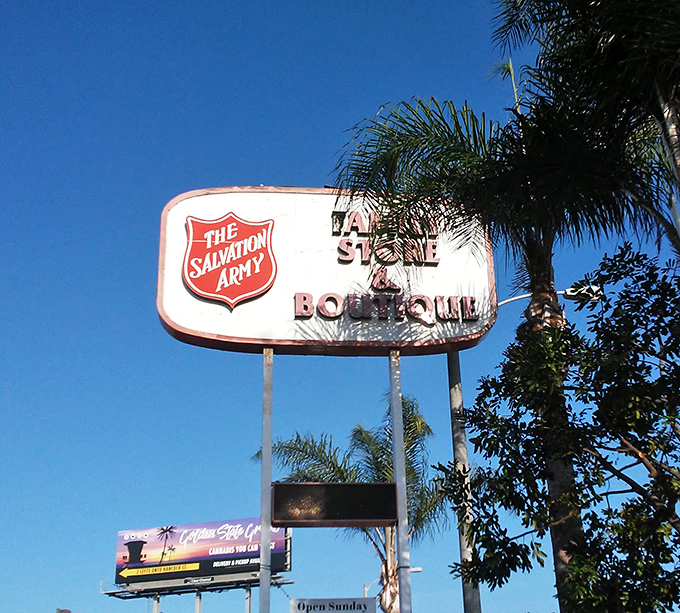 The iconic Salvation Army shield stands tall against San Diego's perfect blue sky. This beacon guides bargain hunters to thrifting nirvana.