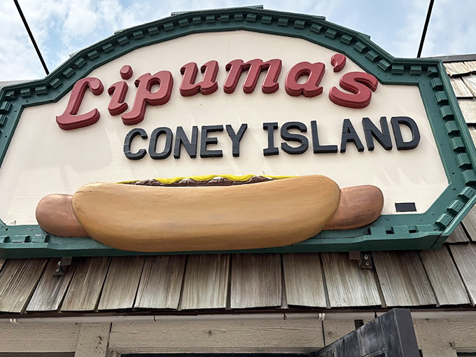 That hot dog sign isn't just signage&mdash;it's a beacon of hope for the hungry. Lipuma's name in lights promises satisfaction that fast food chains can only dream about.