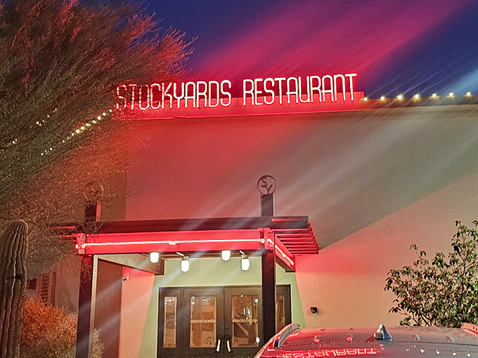 The neon sign glows like a beacon in the night, guiding hungry travelers to their beefy destiny since the mid-20th century.