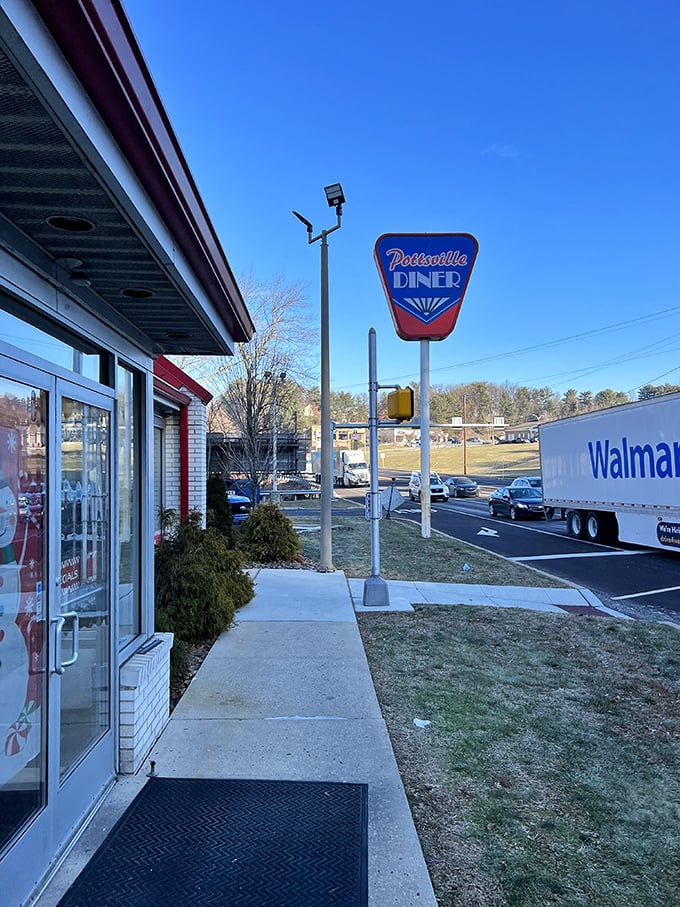 The classic Pottsville Diner sign stands sentinel beside the road, guiding hungry travelers to a taste of Pennsylvania's unpretentious food culture.