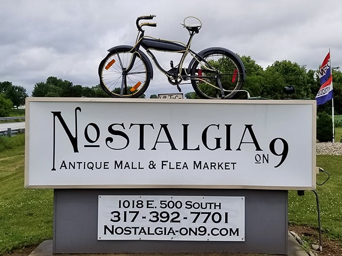 The roadside sign topped with a vintage bicycle announces your arrival at memory lane&mdash;where Nostalgia on 9 isn't just a name, it's a promise.
