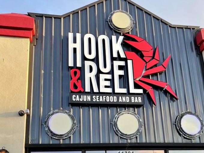 The bold red crab logo against navy siding—a maritime flag signaling "abandon diets, all ye who enter here."