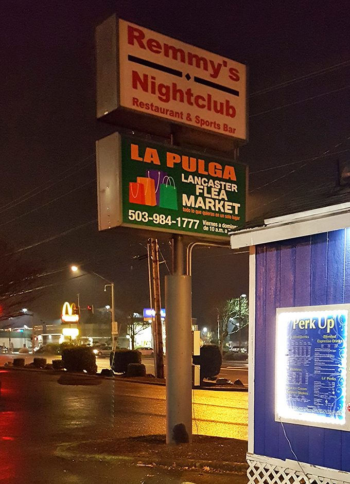 By night, the market's sign glows like a beacon for bargain hunters. Even in darkness, the promise of treasures shines bright.