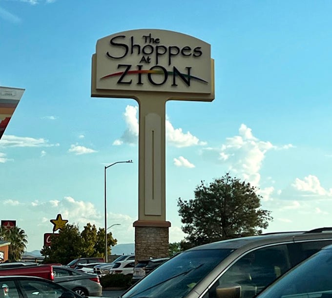 The Shoppes at Zion sign stands tall against Utah's blue sky, a beacon calling to smart shoppers and savvy deal-hunters alike.
