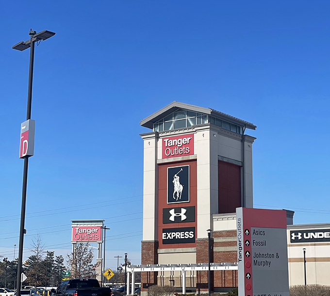 The Tanger tower stands tall, a lighthouse guiding bargain hunters safely to their destination.