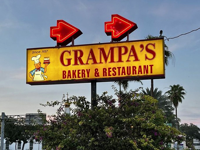 That vintage neon sign glowing like a beacon, guiding hungry travelers to salvation since way back when diners still mattered.