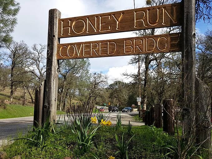 This rustic wooden sign welcomes visitors with the same unpretentious charm that makes the bridge itself so endearing.