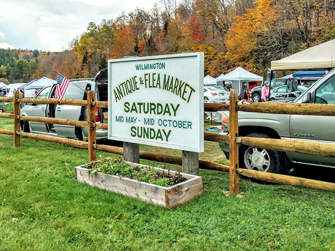 The official welcome sign, framed by autumn's fiery display, announces weekend treasure hunting season&mdash;Vermont's most colorful shopping experience.